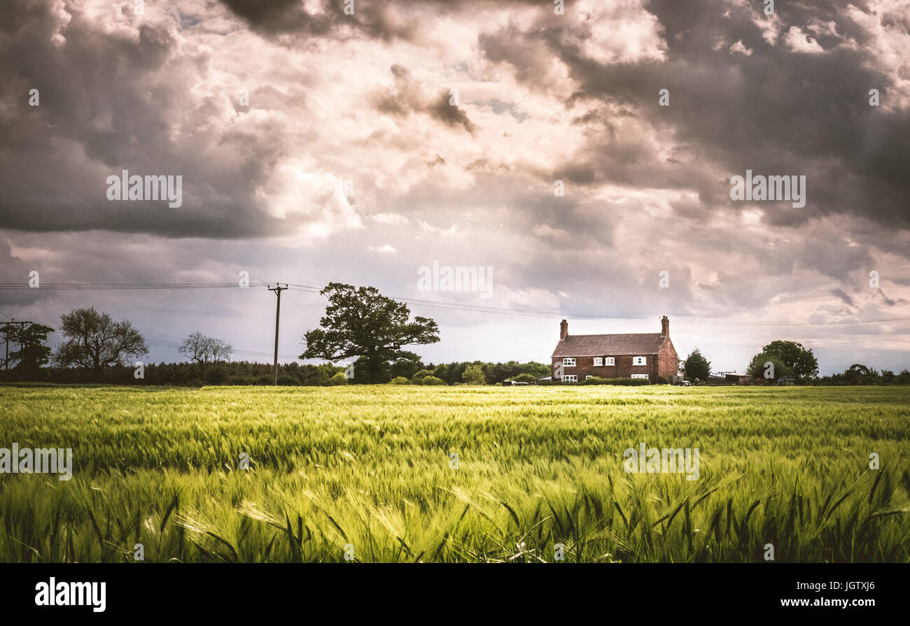 Farmhouse in a storm Stock Photo - Alamy