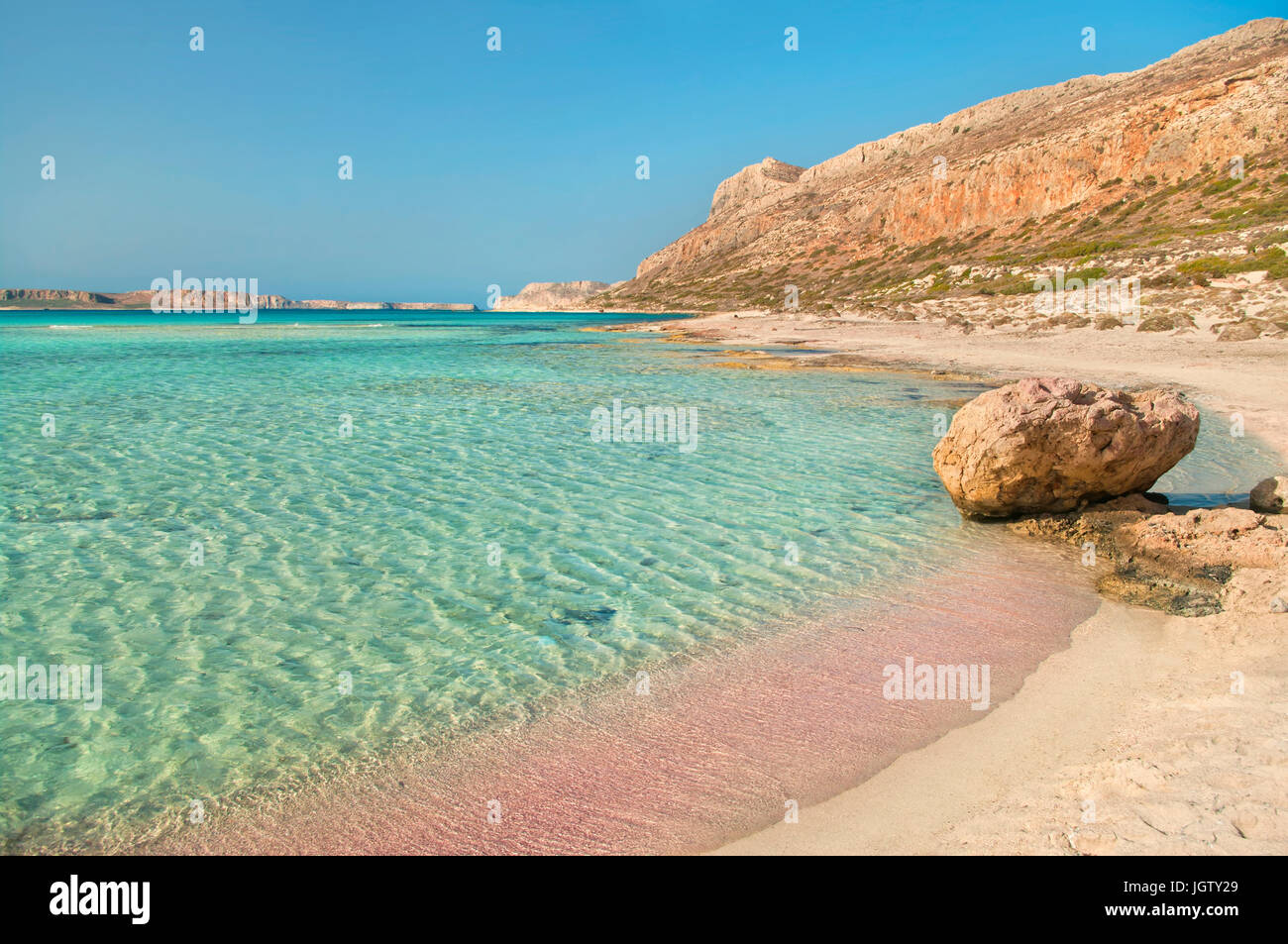 view of mountains and famous pink sanded beach with turquoise blue ...