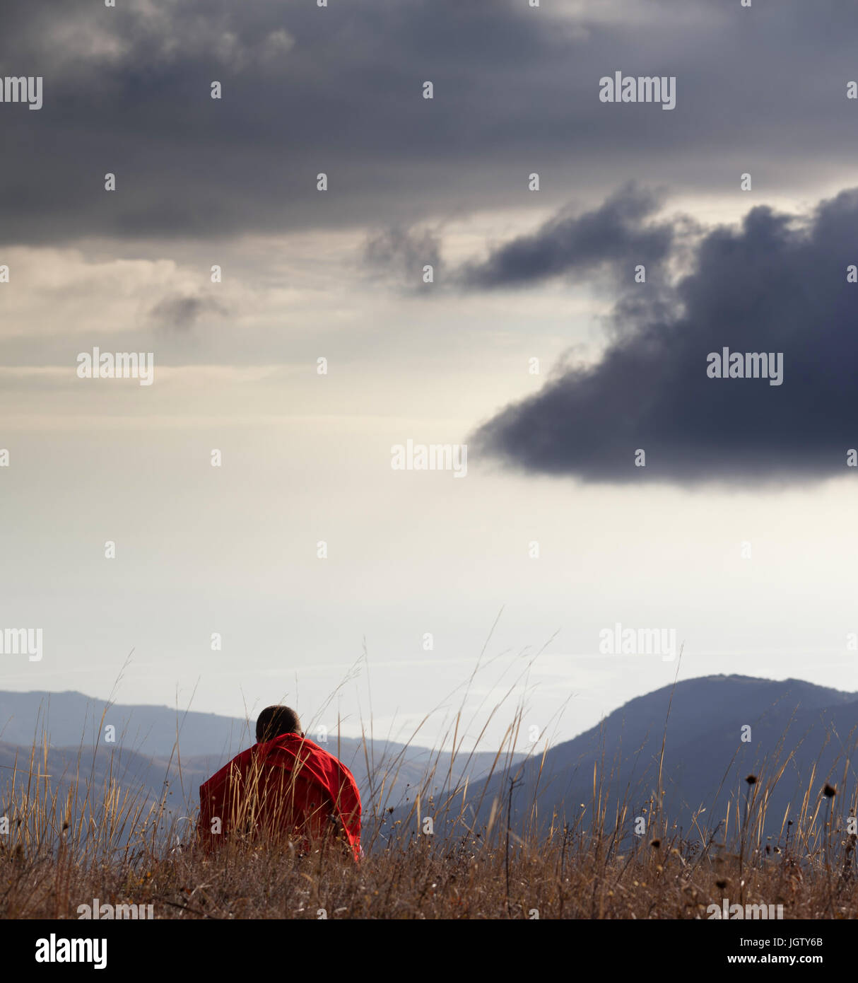 Man resting at mountains in sun evening Stock Photo - Alamy