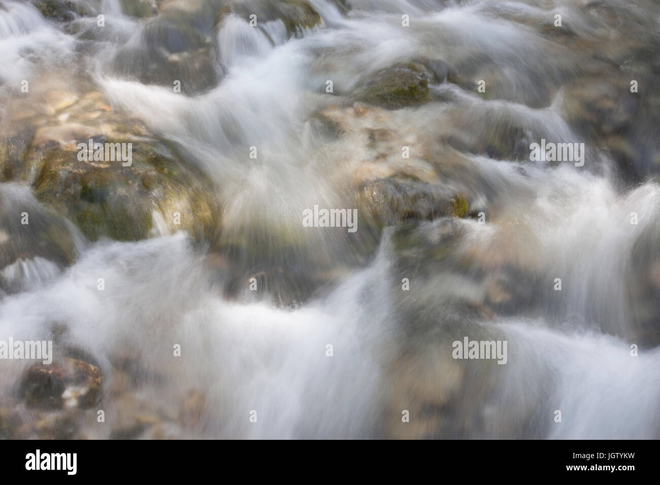 Water flowing on rocks with moss background Stock Photo - Alamy