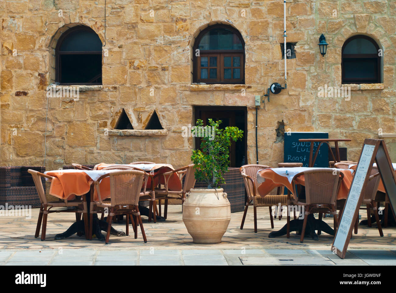 empty restaurant outside in Latchi village, cyprus Stock Photo - Alamy