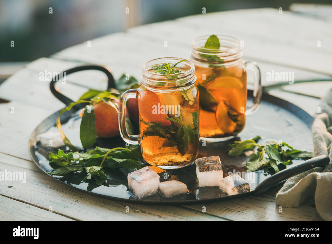 Summer refreshing cold peach ice tea on wooden table Stock Photo - Alamy