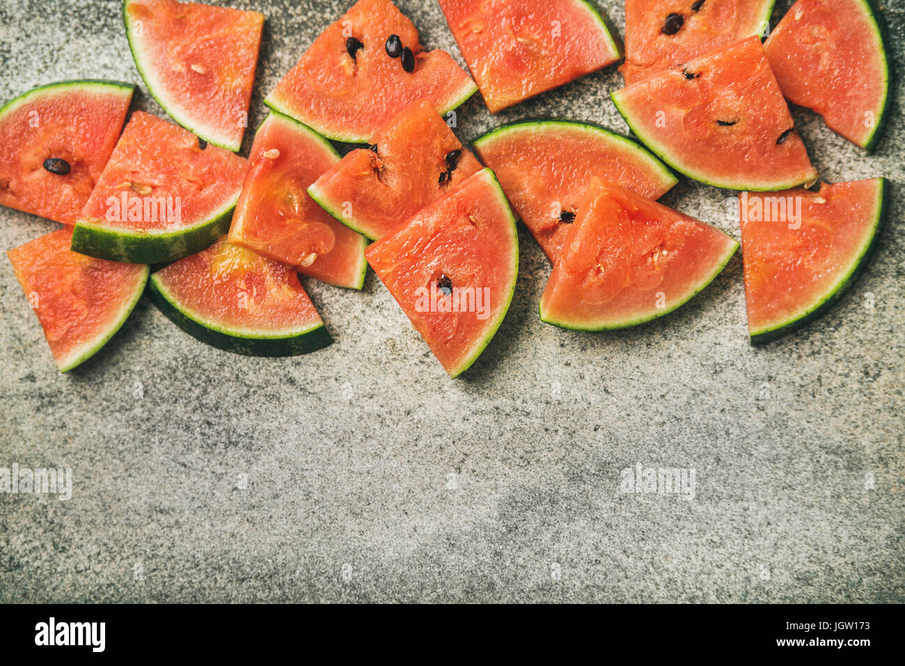 Juicy watermelon pieces over concrete stone background Stock Photo - Alamy