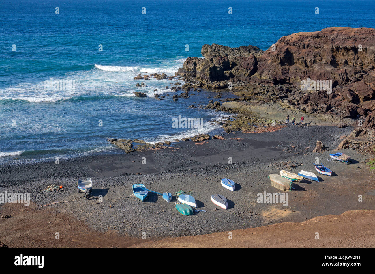 Fishing boats at lava beach, El Golfo, Lanzarote island, Canary islands ...