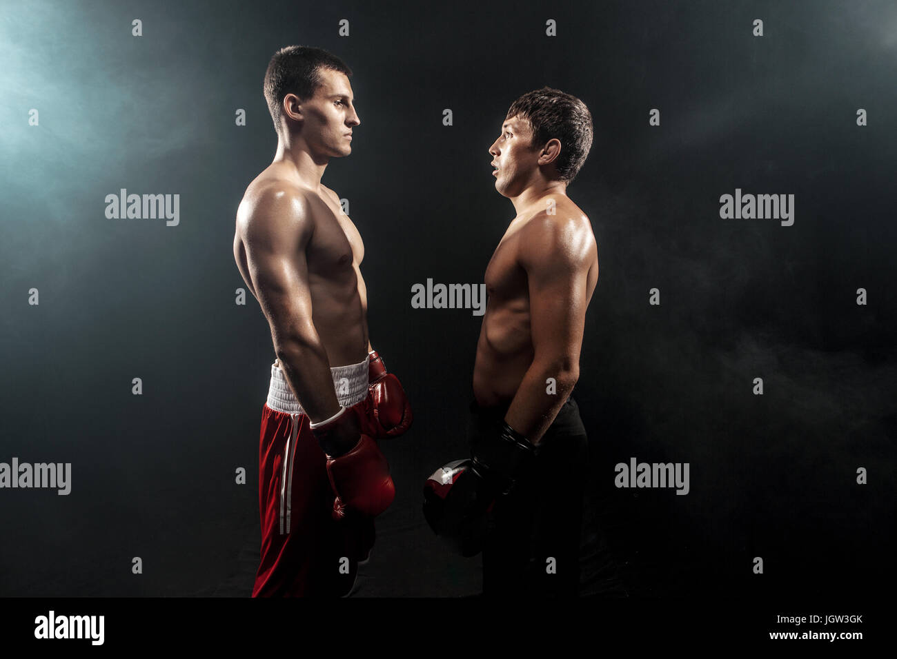 Two professional boxer standing on black smoky background Stock Photo ...