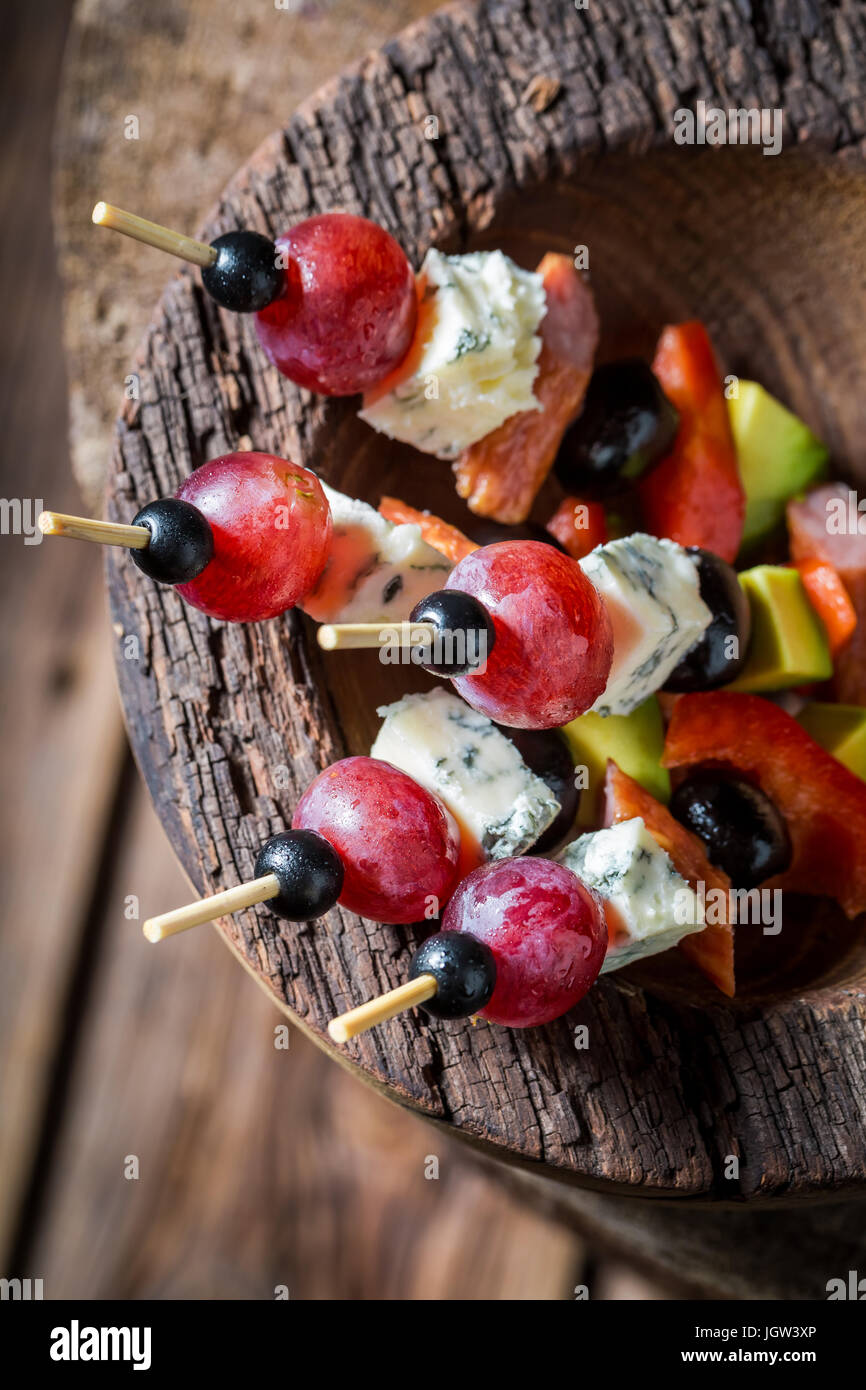 Tasty cold snacks with fresh ingredients in wooden bowl Stock Photo - Alamy