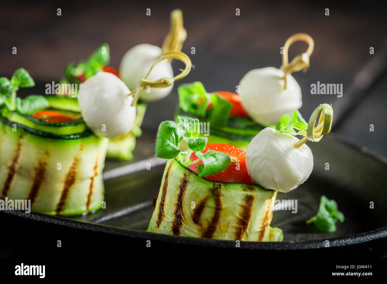 Various finger food made of fresh ingredients on burnt table Stock ...