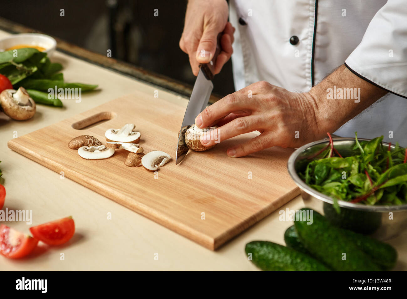 Mature man professional chef cooking meal indoors Stock Photo - Alamy