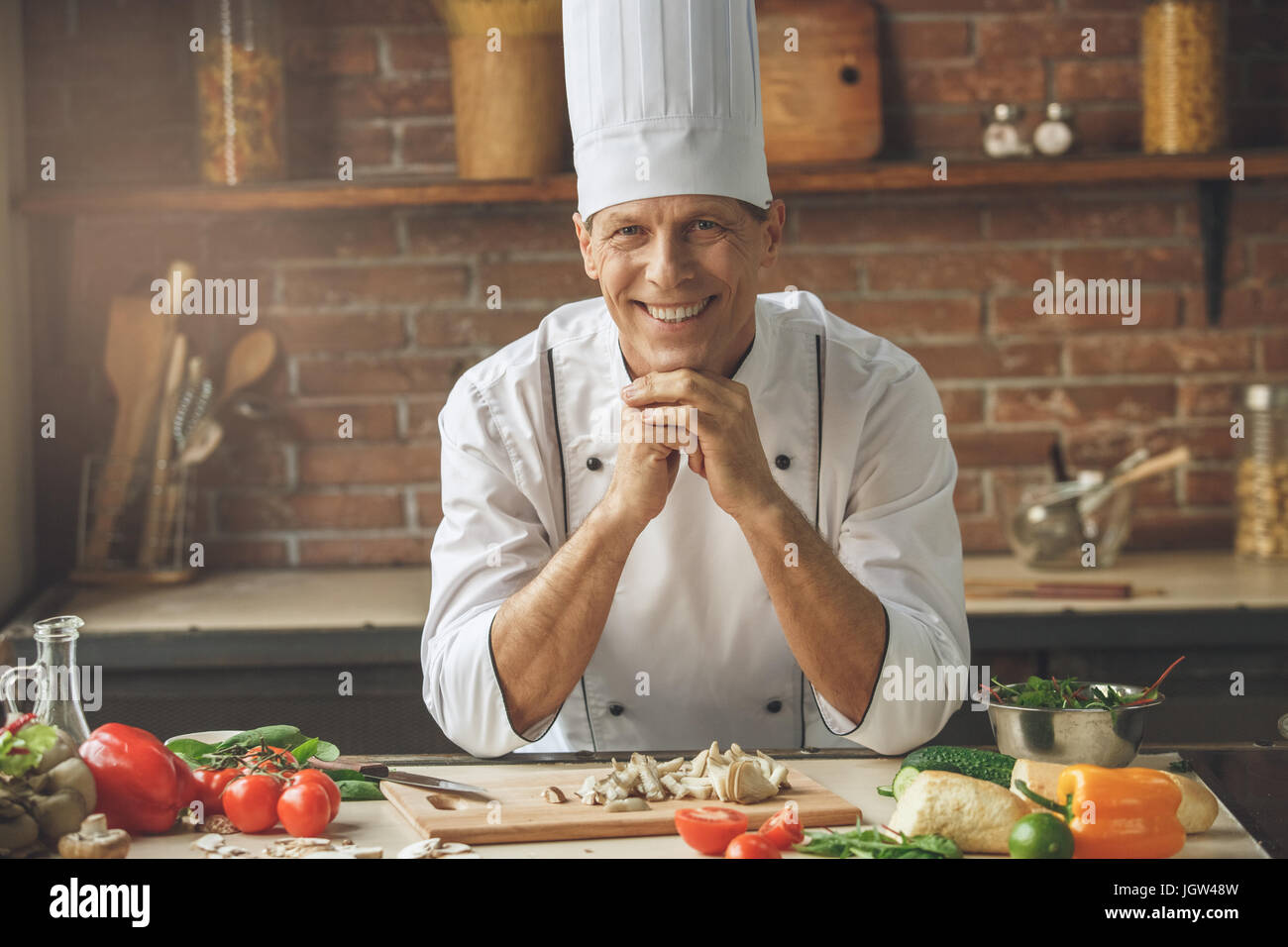 Mature man professional chef cooking meal indoors Stock Photo - Alamy