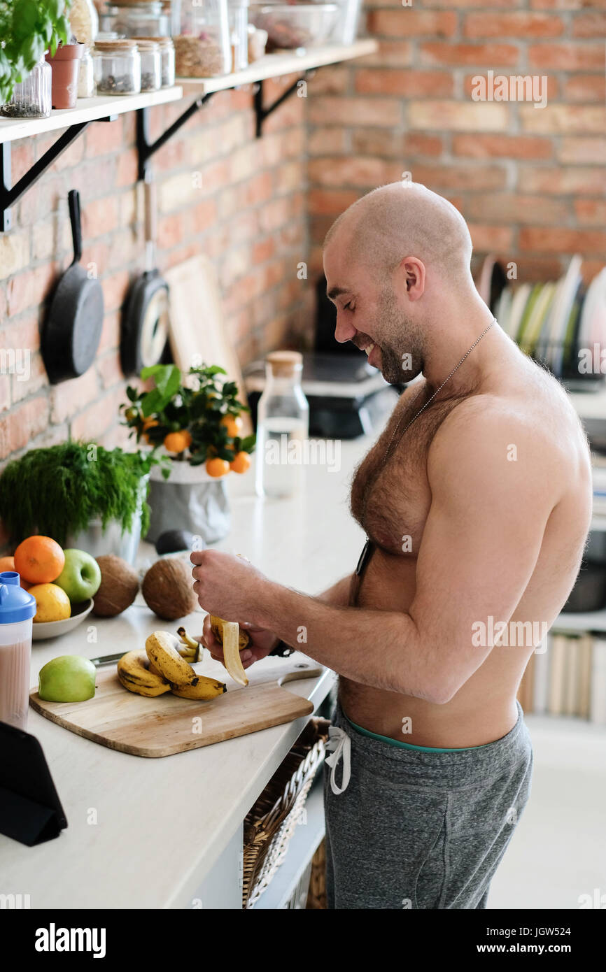 Handsome, shirtless man at kitchen Stock Photo - Alamy