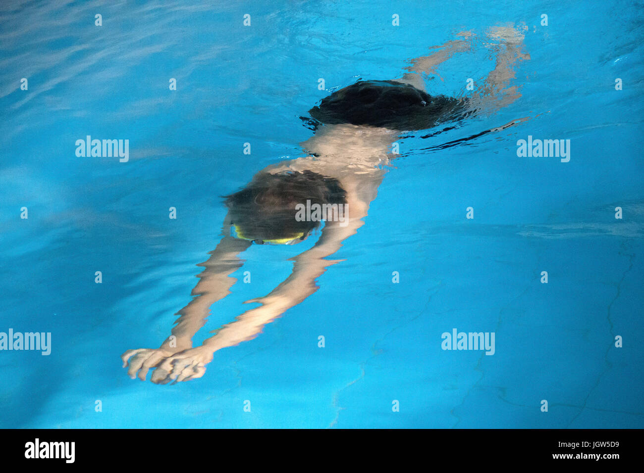 Boy learning to swim in swimming pool Stock Photo - Alamy