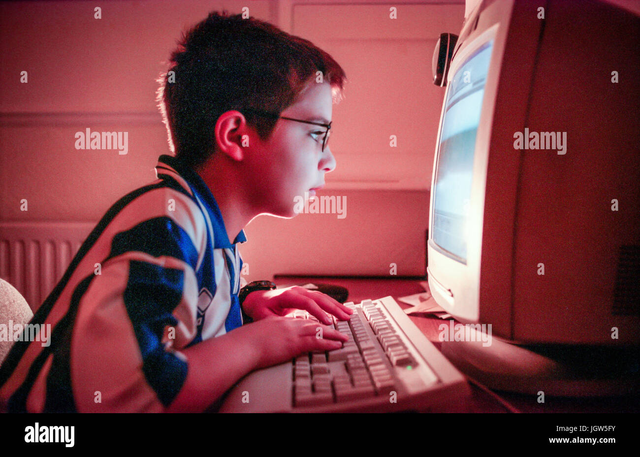 Young boy aged 12 staying up late on his computer Stock Photo - Alamy