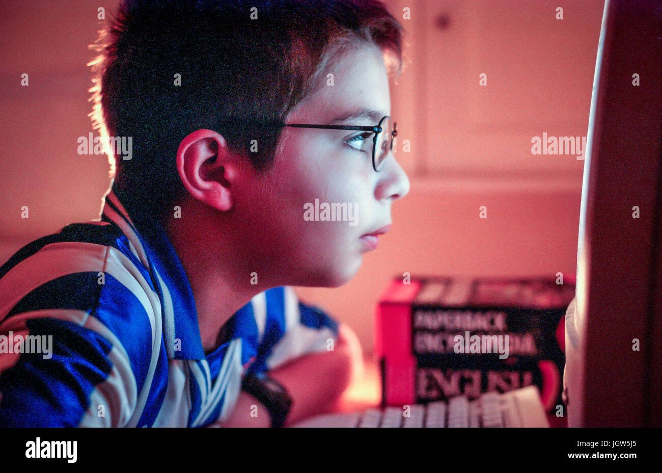 Young boy aged 12 staying up late on his computer Stock Photo - Alamy