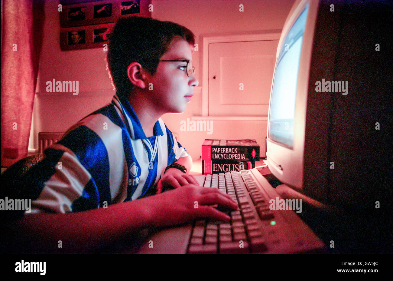 Young boy aged 12 staying up late on his computer Stock Photo - Alamy