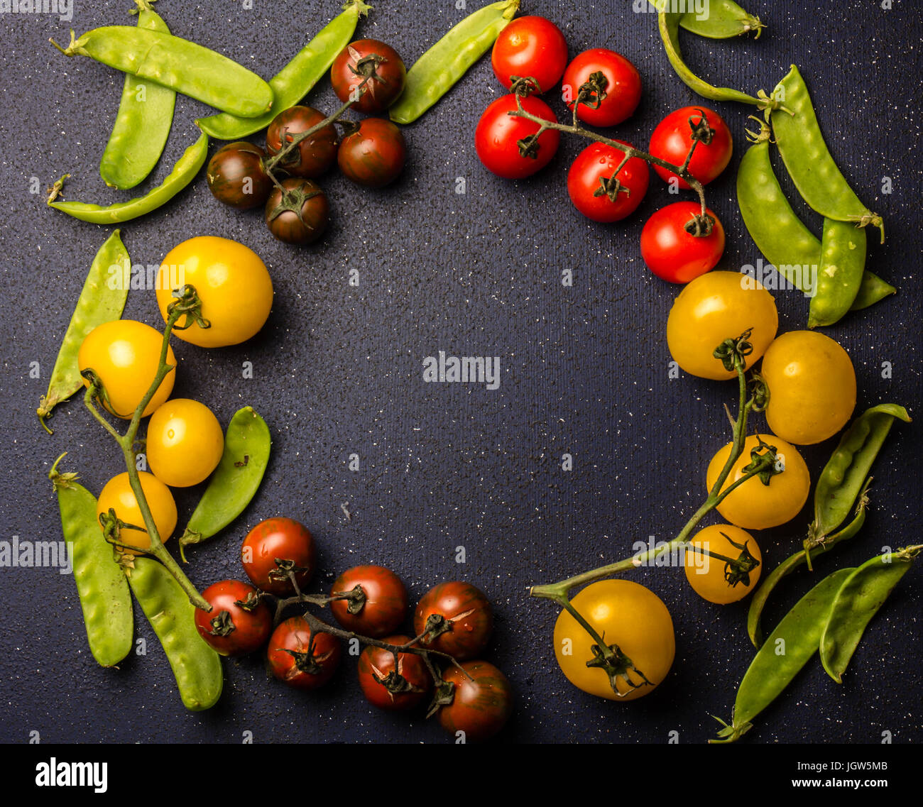 Food cooking background with red and yellow tomatoes and green pea ...