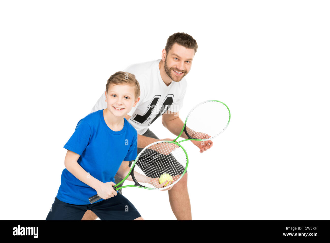side view of active father and son with tennis racquets isolated on ...