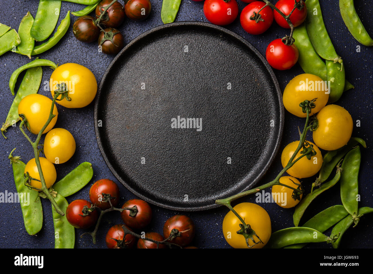 Food background with copy space. Red and yellow tomatoes and green pea ...