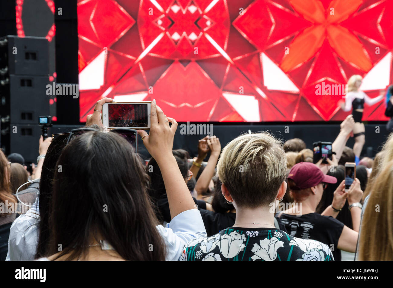 Filming and tacking pictures of entertainment on stage at the London ...