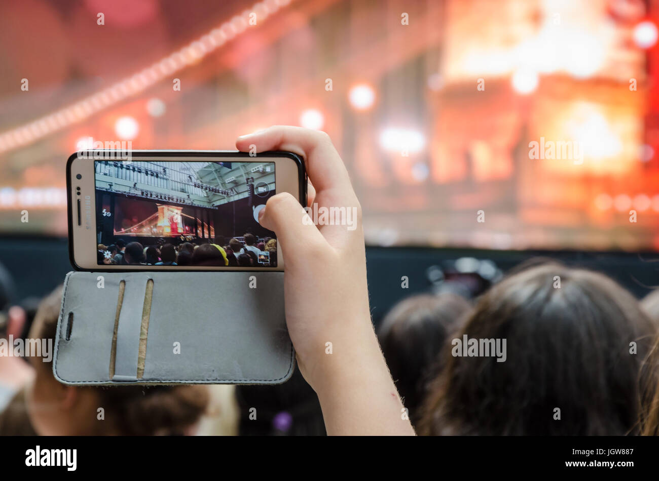 Filming and tacking pictures of entertainment on stage at the London ...