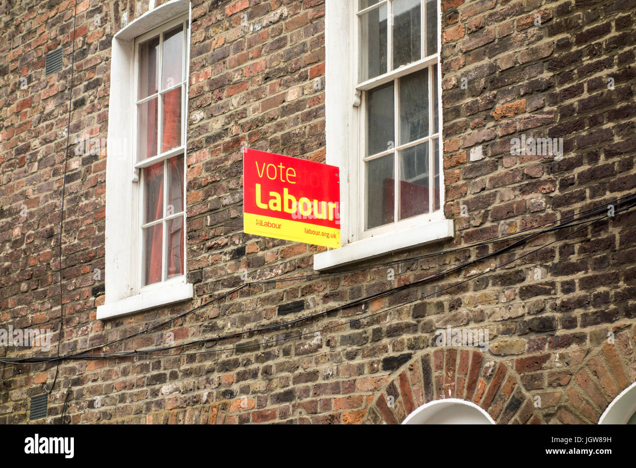 Vote Labour sign outside a traditional London terrace house / terraced ...
