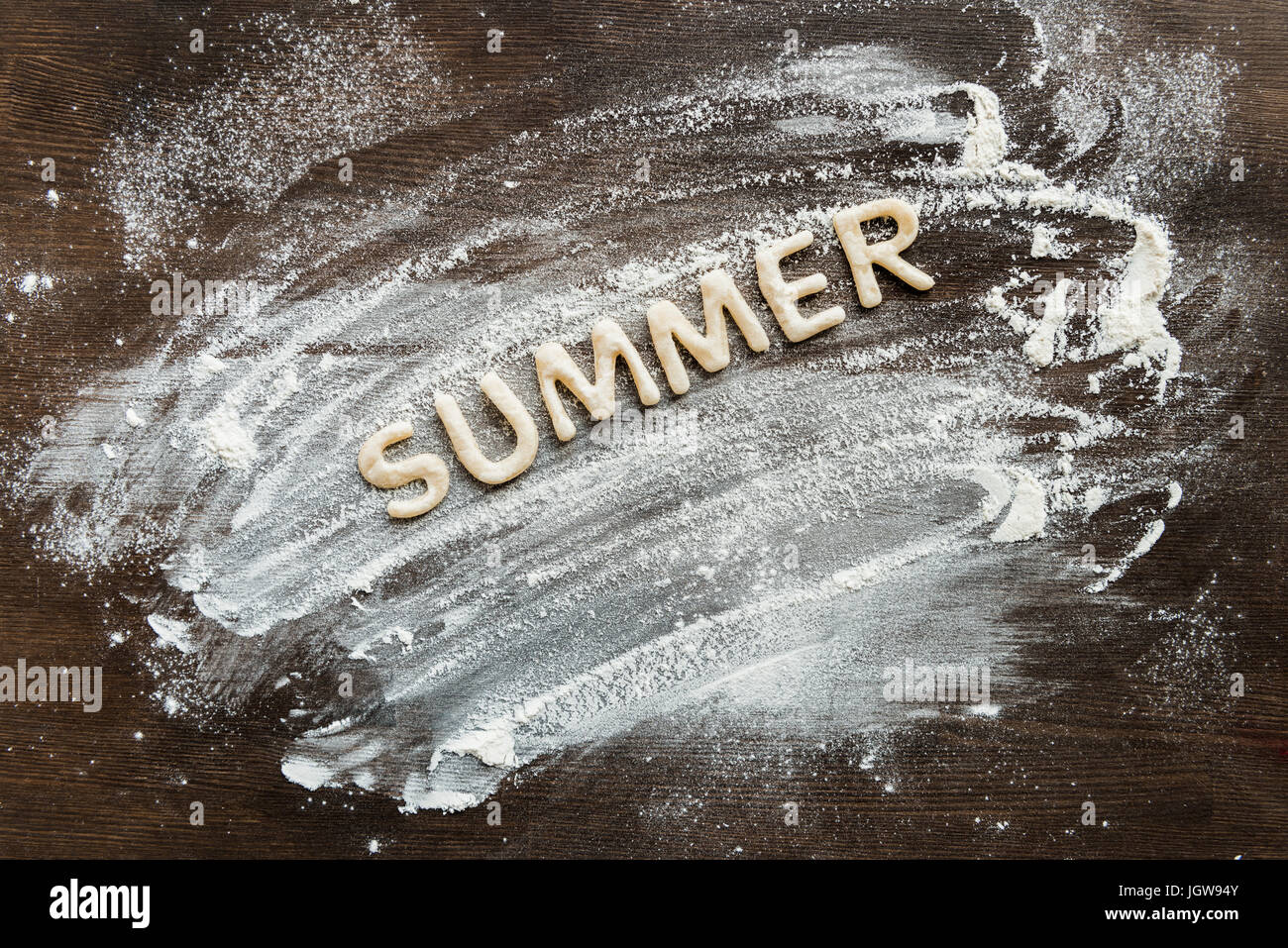 Top view of edible word summer made from sweet crunchy cookies, baking ...