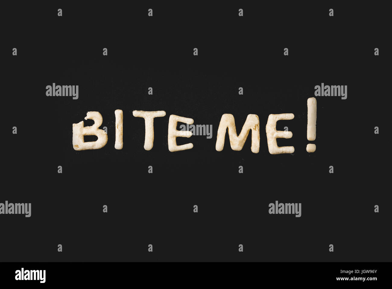 top view of lettering bite me made from cookie dough isolated on black ...