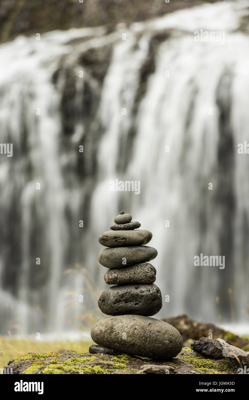 Stack of pebbles and waterfall Stock Photo - Alamy