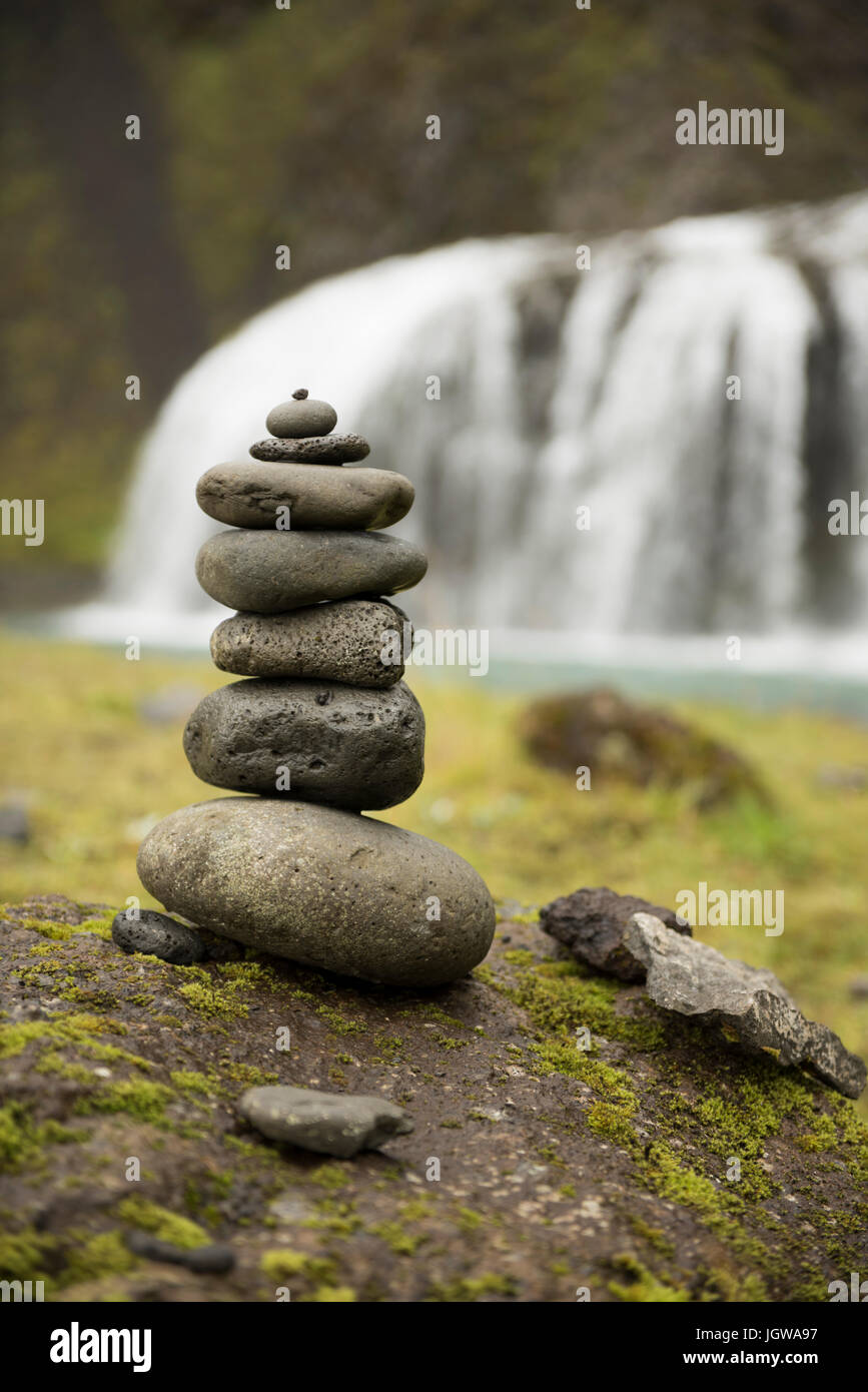 Stack of pebbles and waterfall Stock Photo - Alamy