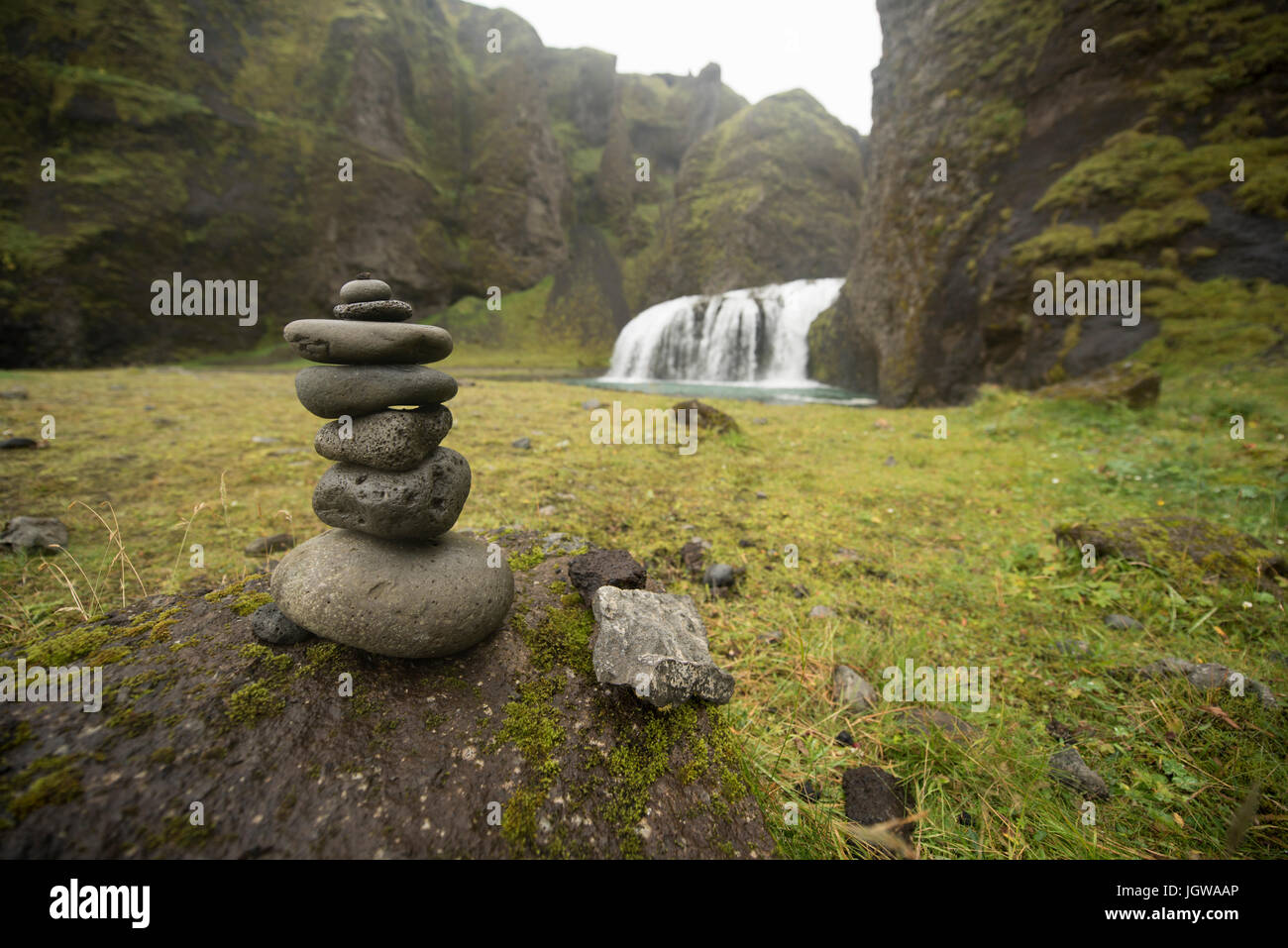 Stack of pebbles and waterfall Stock Photo - Alamy