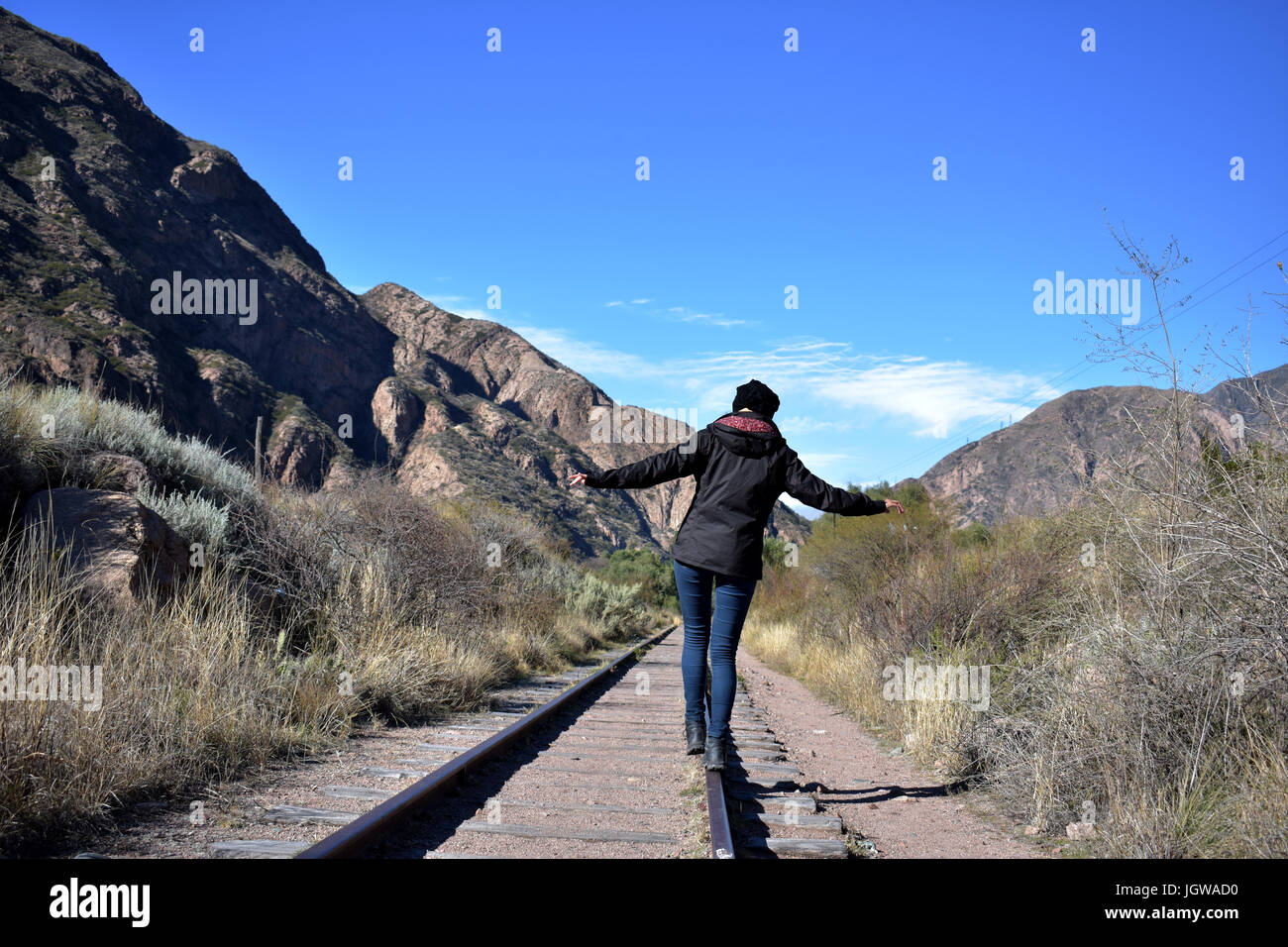 woman walking on railroad track Stock Photo - Alamy