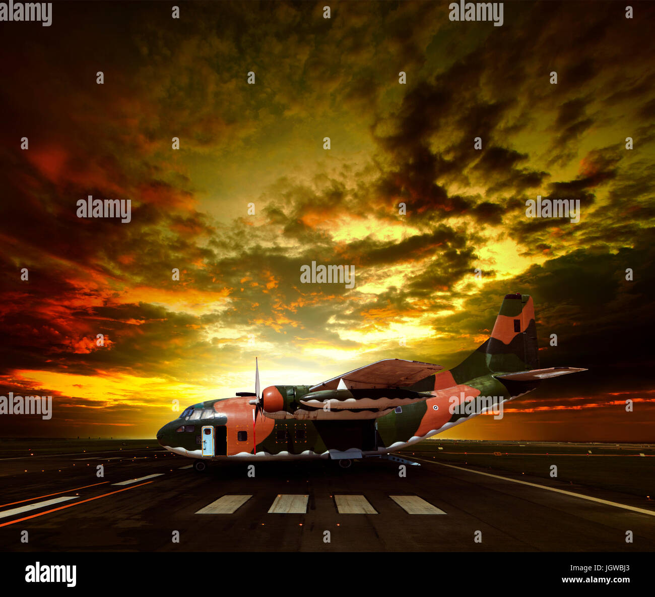 military plane on airport runway against beautiful sun rising sky Stock ...
