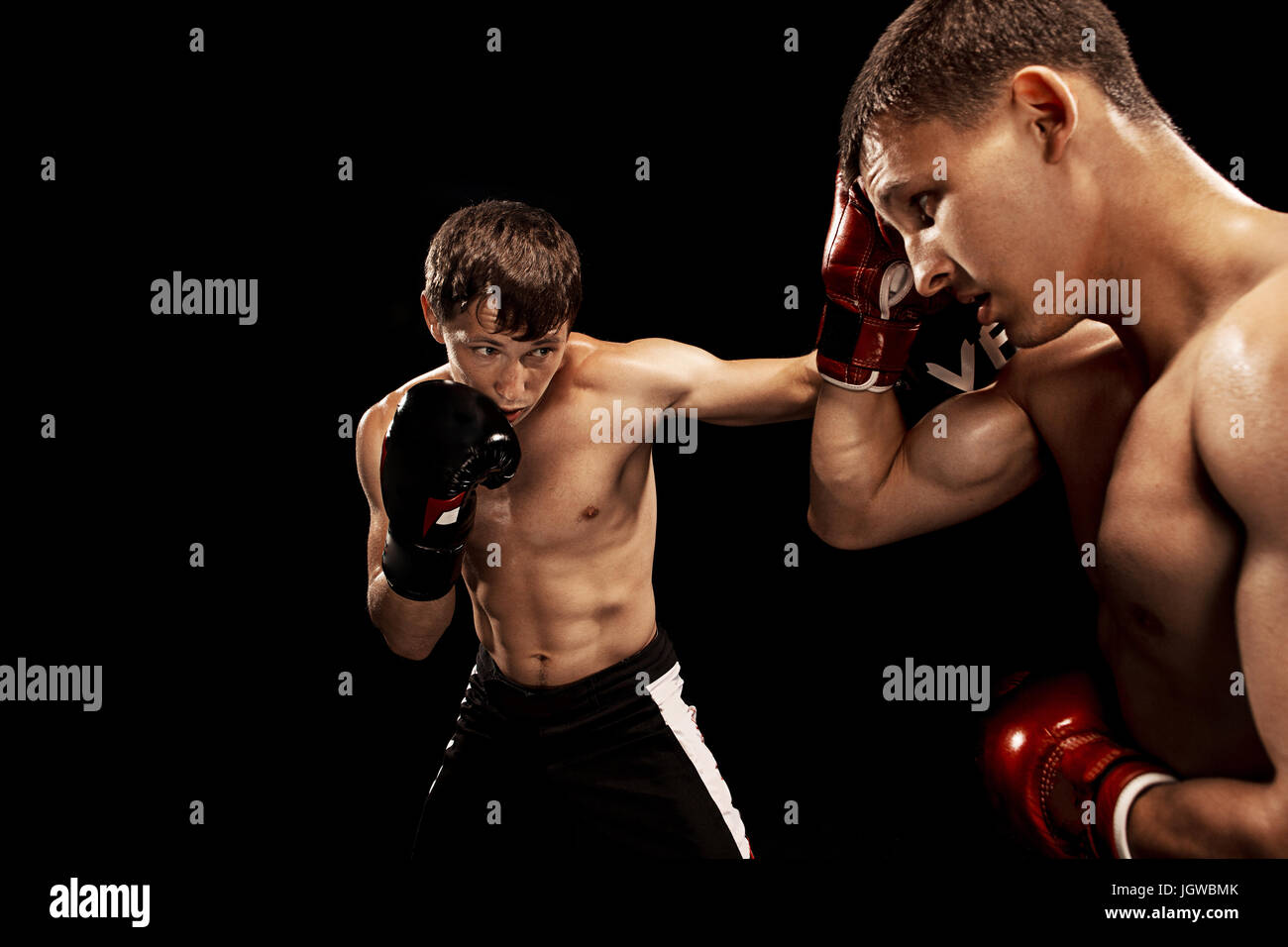 Two professional boxer boxing on black background Stock Photo - Alamy