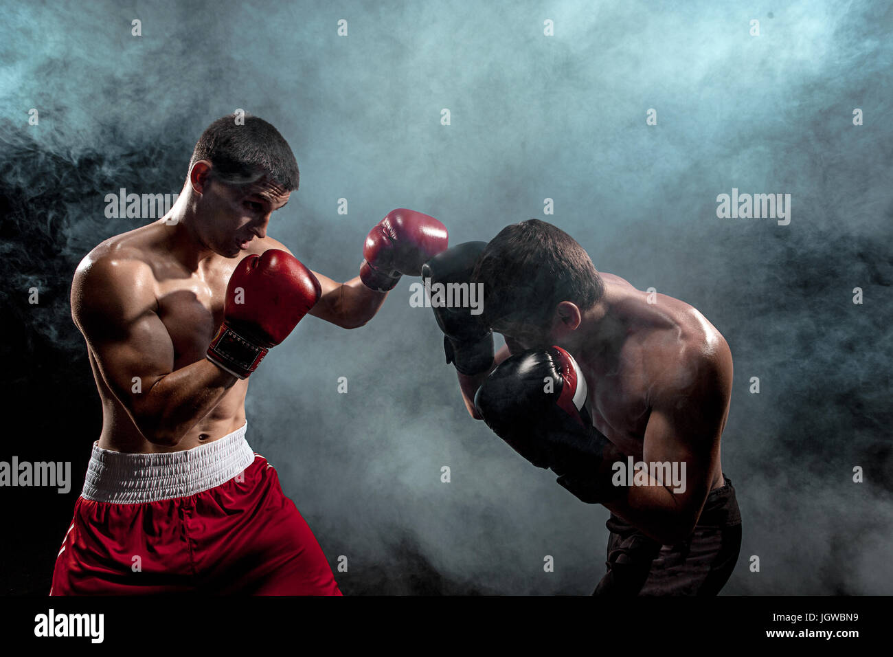 Two professional boxer boxing on black smoky background Stock Photo - Alamy