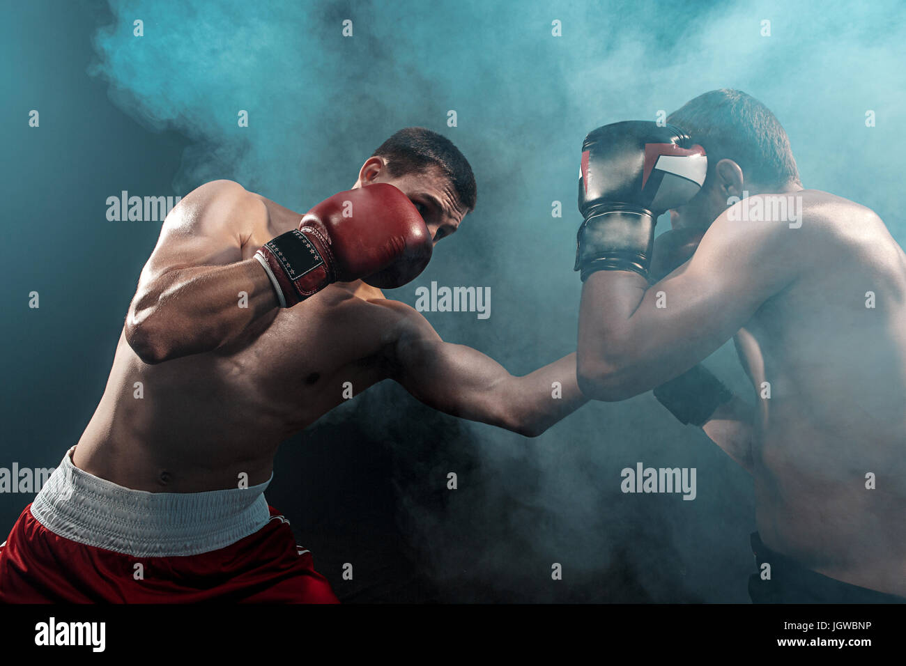 Two professional boxer boxing on black smoky background Stock Photo - Alamy