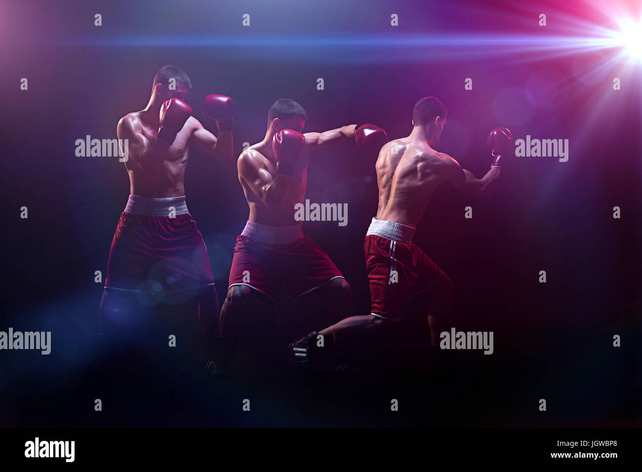 The boxer boxing in a dark studio Stock Photo - Alamy