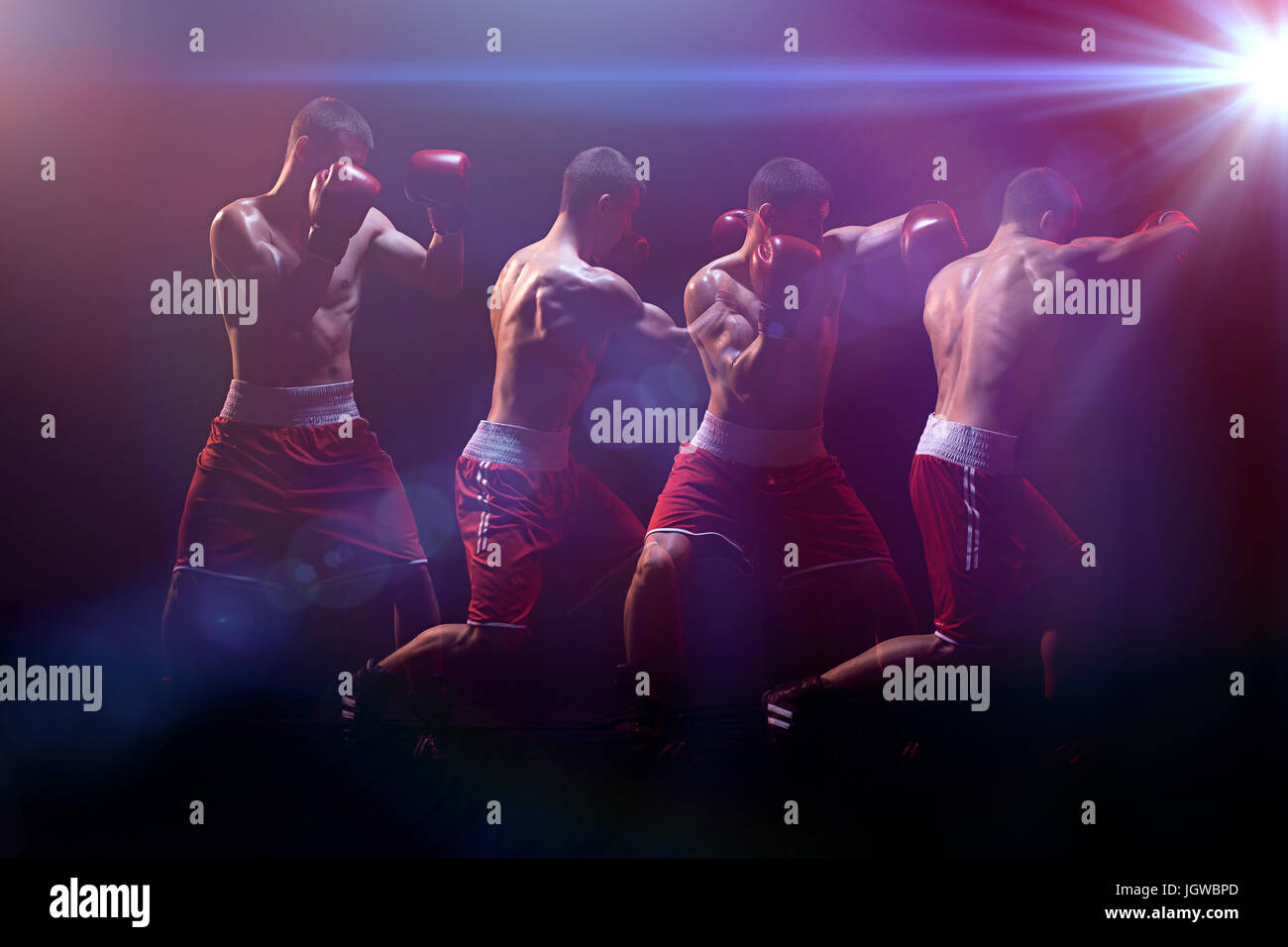 The boxer boxing in a dark studio Stock Photo - Alamy