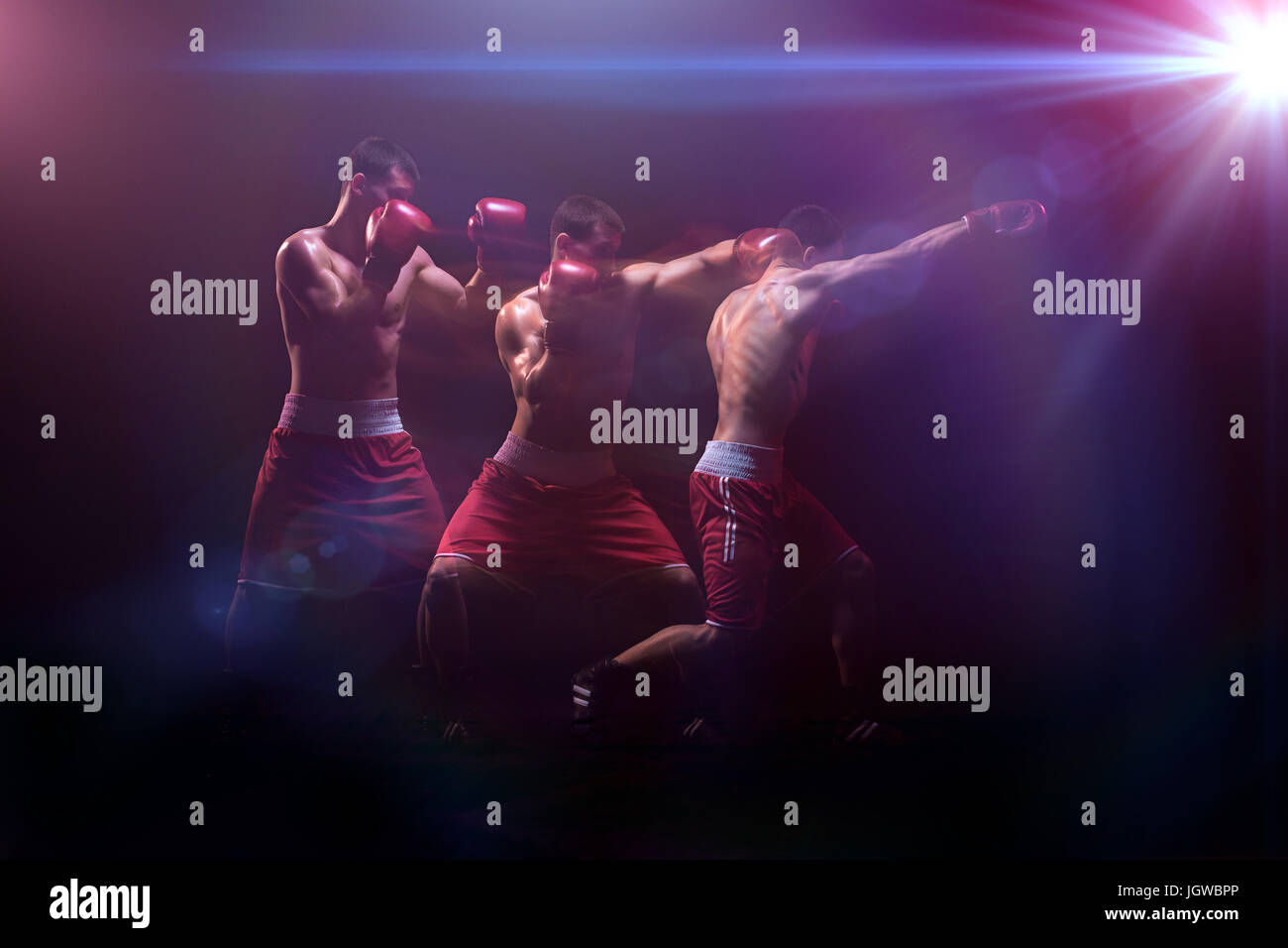 The boxer boxing in a dark studio Stock Photo - Alamy