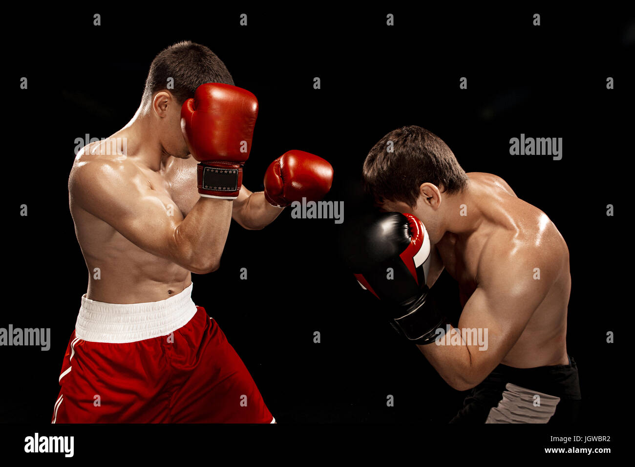 Two professional boxer boxing on black background Stock Photo - Alamy