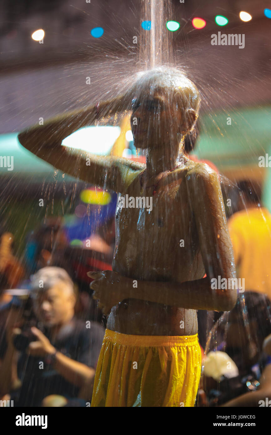 Young hindu pilgrim taking shower before his kavadi walk to batu cave ...