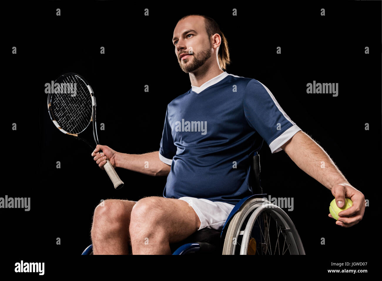 Handicapped young sportsman playing tennis isolated on black Stock ...