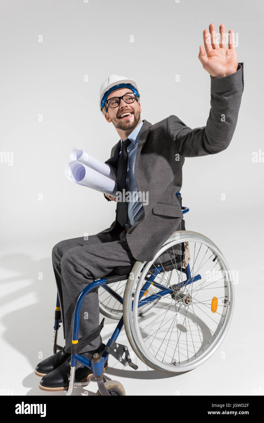 happy disabled architect in wheelchair greeting someone isolated on ...