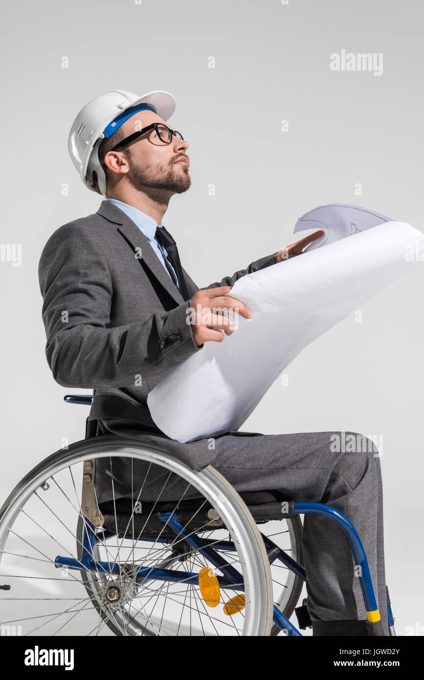 disabled architect in wheelchair holding blueprint isolated on white ...