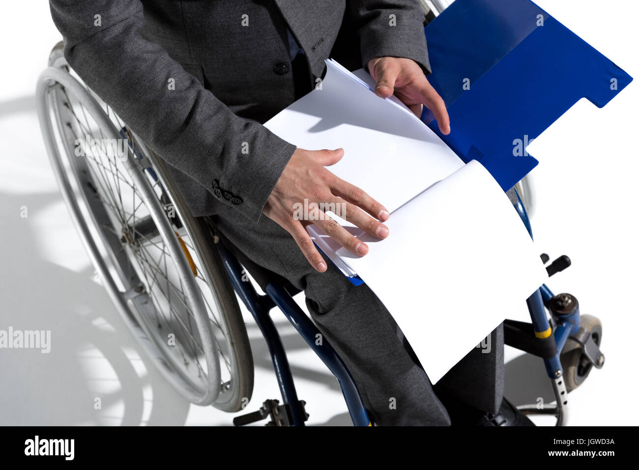 cropped shot of physically handicapped businessman in wheelchair with ...