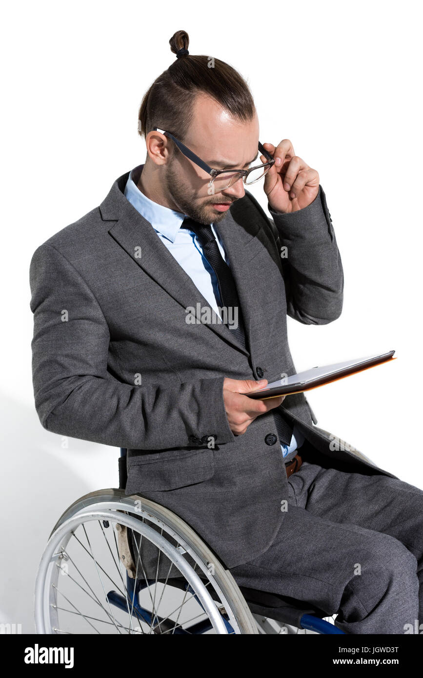 young physically handicapped businessman in wheelchair using digital ...
