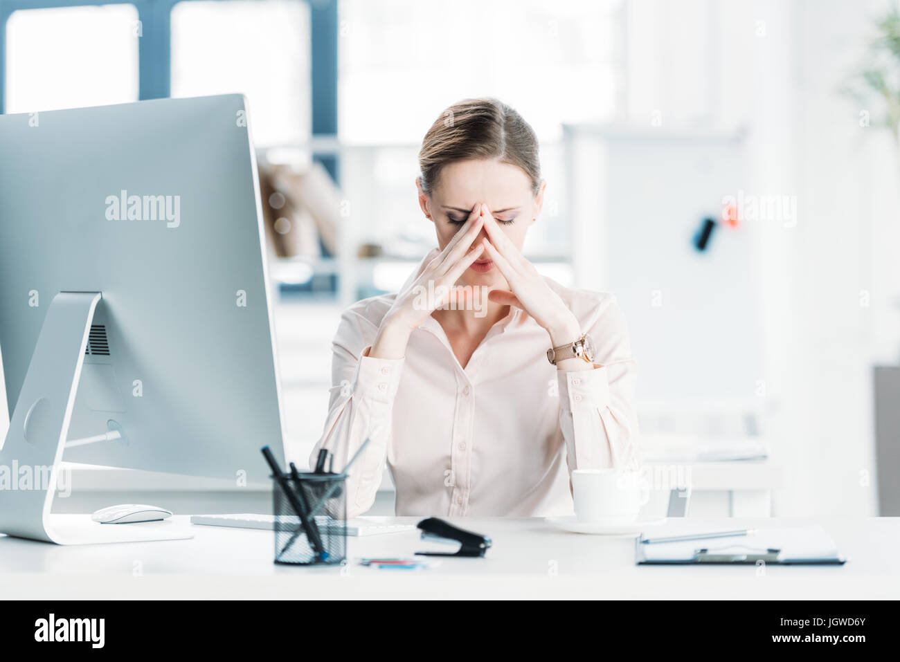 Young tired businesswoman sitting near computer at modern office Stock ...