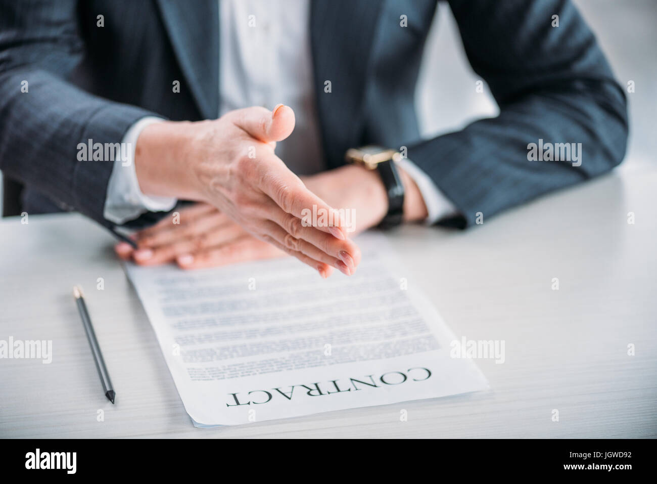 Partial view of businesswoman extending hand for handshake with ...