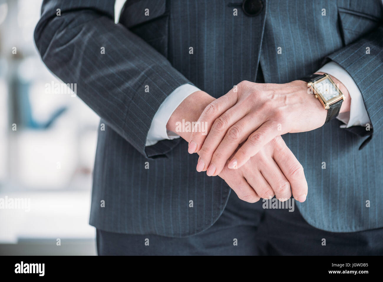 Close-up partial view of hands of senior businesswoman in formal wear ...