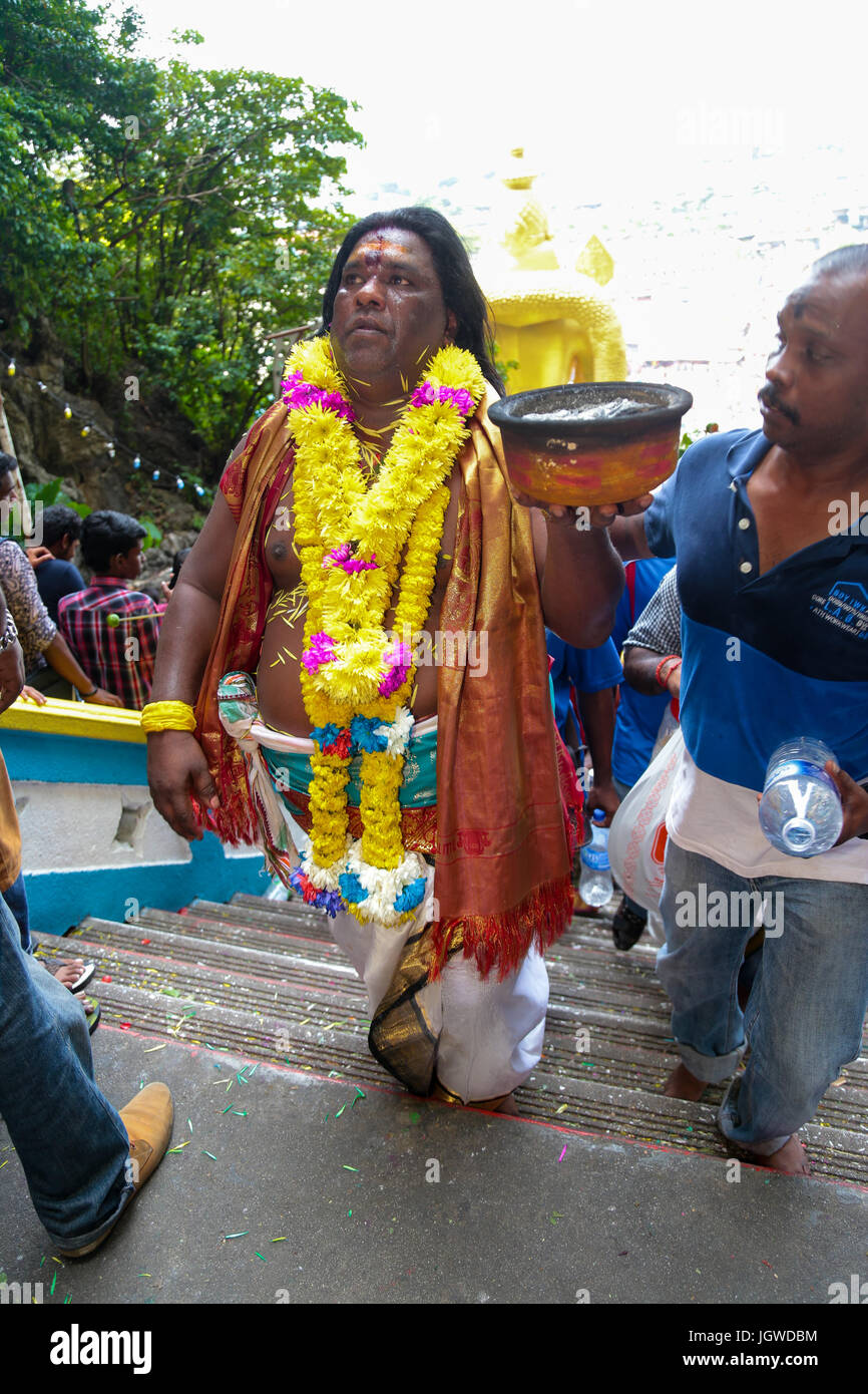 Hindu pilgrim with fire stove kavaldi climbing the batu cave temple ...