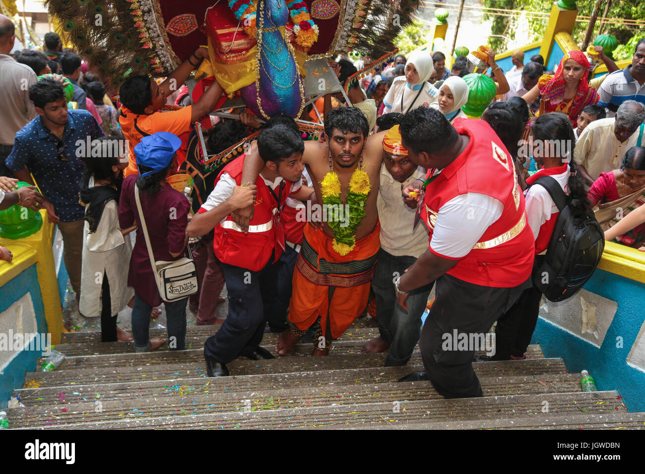 Ambulance crews helping a collapsed hindu pilgrim at the batu cave ...