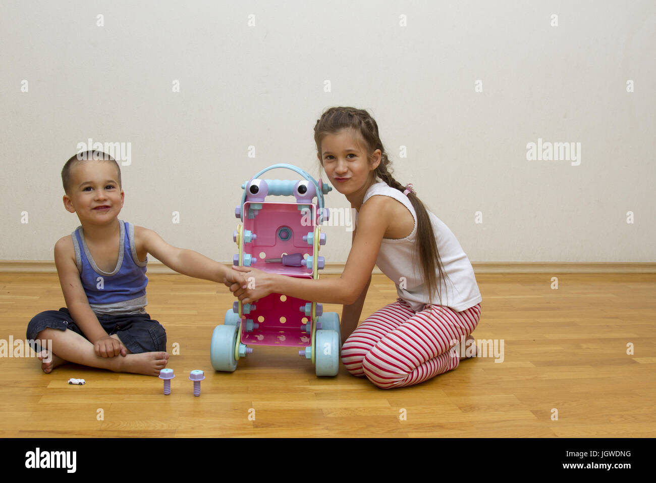 Brother and sister play with toys Stock Photo - Alamy